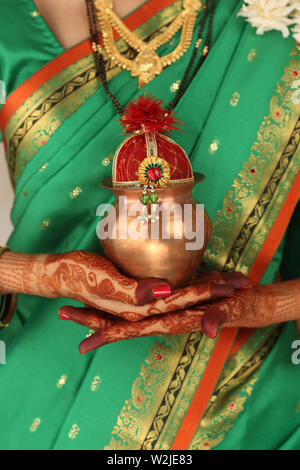 Woman holding a kalash Stock Photo - Alamy