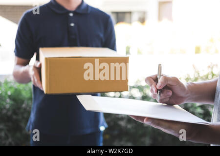 Delivery mail man giving parcel box to recipient and signature form ...