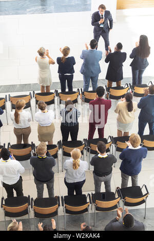 Diverse executives clapping at meeting in conference room Stock Photo ...