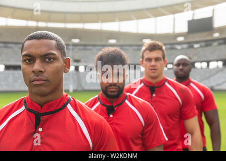 Male rugby players standing together with rugby ball in stadium Stock ...