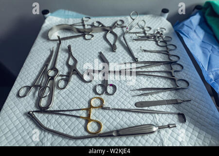 Surgical instruments arranged on table in operating room of hospital ...