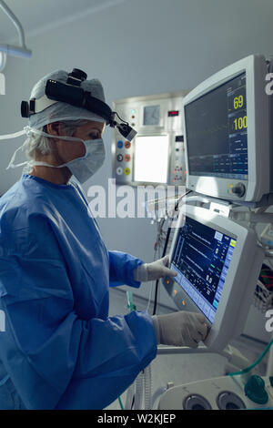 Female surgeon using monitor in operation theater Stock Photo - Alamy