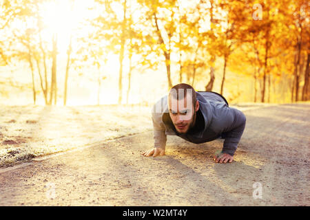 A Caucasian Fitness guy workout pushups with kettlebells Stock Photo ...