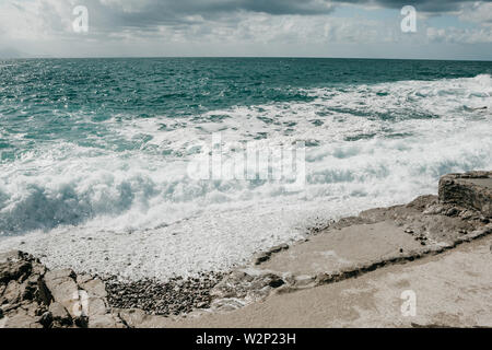 Restless sea near the stone coast. Natural landscape Stock Photo - Alamy
