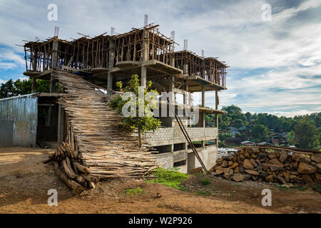 Building under construction with eucalyptus wood scaffolding in Metu ...