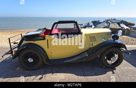Cream old Vintage car, front radiator grille, chrome and headlights ...
