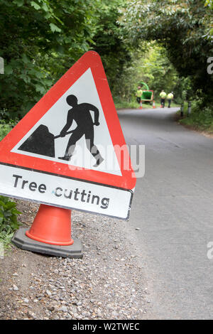Tree cutting men at work warning signs, in the woods for walkers Stock ...