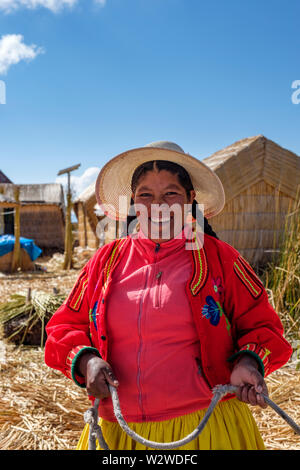 Smiling local Uru indigenous women greeting tourist / tourists to a ...