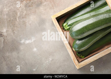Box with fresh zucchini squashes on grunge background Stock Photo - Alamy