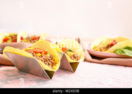 Stand with tasty fresh tacos on color background Stock Photo - Alamy