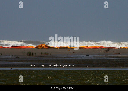 Oil booms tossed around in the ocean outside Port Eads at the mouth of ...