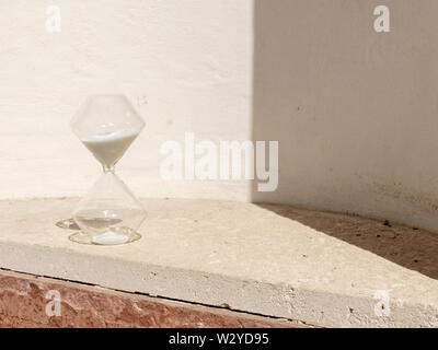Hourglass and Sun Measuring Time Stock Photo - Alamy