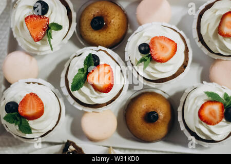 Delicious birthday cupcakes on table on bright background Stock Photo ...