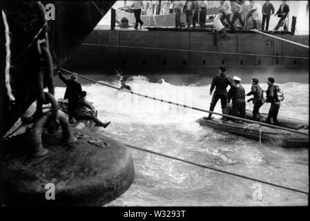 A SAILOR IS RESCUED FROM THE SUNKEN SUBMARINE HMS ARTEMIS WHICH SANK ON ...