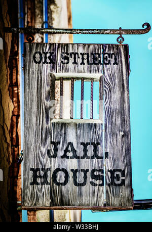 A handmade wooden sign hangs overhead the entrance to the OK Street ...