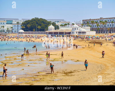 Spain, Andalusia, Cadiz, La Caleta beach, young people playing beach ...