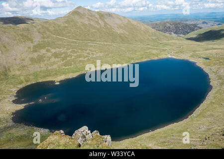 Helvellyn mountain peak and Red Tarn corrie lake, Lake District ...