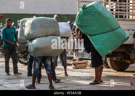 Men carrying heavy loads on their backs, Shillong, Meghalaya, India ...