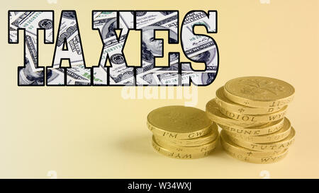 "TAXES" word with notes inscribed and coin stack in front. Pile of ...