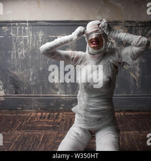 Mummy screams in horror and tears the bandages. The girl with the ...