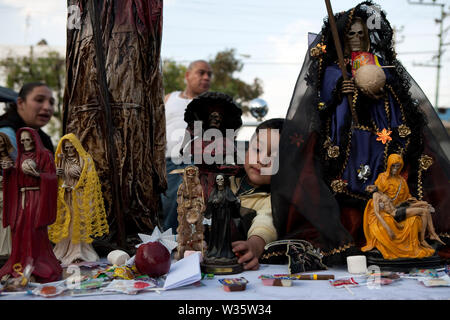 Mexican devotees of Santa Muerte (Holy Death) recite a prayer during a ...