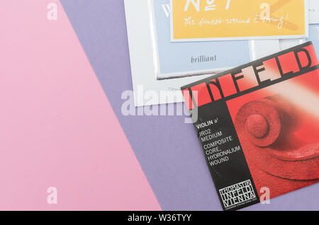 mixed violin string packs on a pink colored surface Stock Photo - Alamy