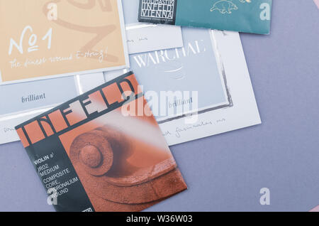 mixed violin string packs on a pink colored surface Stock Photo - Alamy