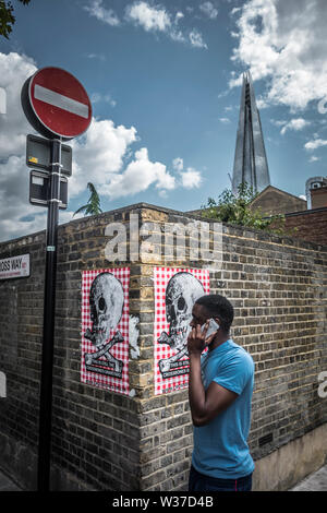 A skull and crossbones poster outside the Crossbones pauper's cemetery ...