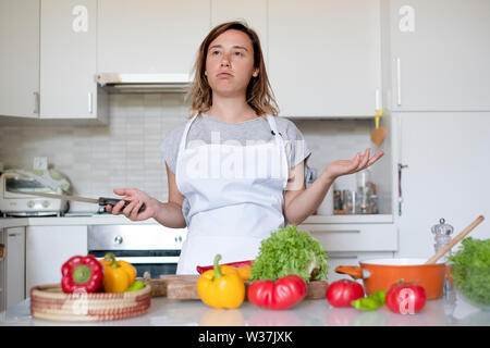 tired housewife cooking in kitchen Stock Photo - Alamy