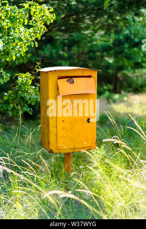 Vintage rusted mail box on black iron gate Stock Photo - Alamy