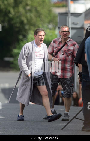 Barry, UK. 13th July, 2019. "Uncle Bryn" played by Rob Bryden films a ...