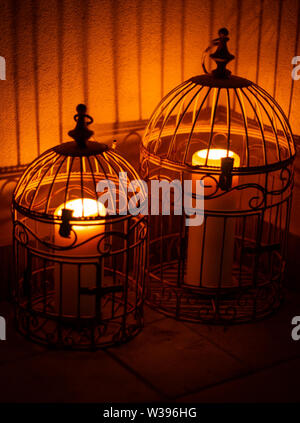 Caged candle lights with shadows on the wall Stock Photo - Alamy
