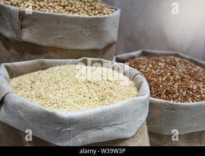 Sacks of red and white jasmine rice, and black and white sticky rice ...