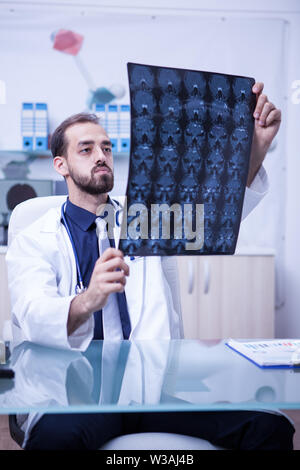 Handsome caucasian man holding brain and lightbulb for inspiration and ...