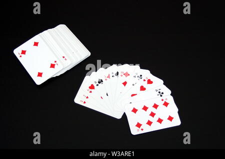 A set of playing cards are ready and lying on a black table Stock Photo ...