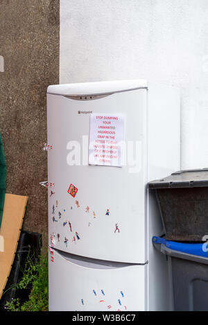 Fly tipping - Fridge freezer dumped on waste ground - UK Stock Photo ...