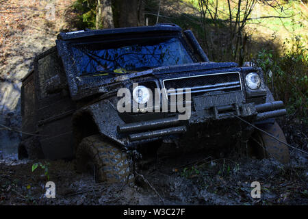 SUV stuck in a rut on a bad impassable road in the woods of Siberia ...