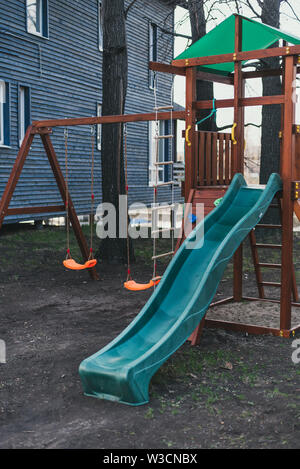 View of children's complex with slide on playground Stock Photo - Alamy