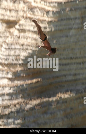 A cliff diver jumps from the landmark Raouche sea rock, during ...