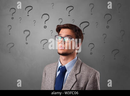 Person with question marks around face Stock Photo - Alamy