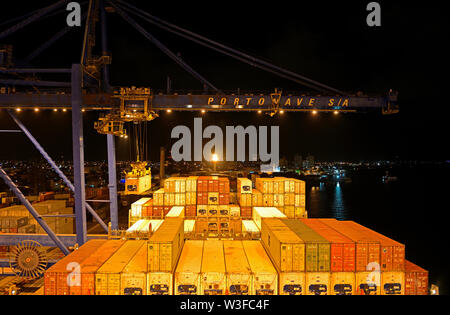 operation of container terminal at night. Unloading container ship at ...
