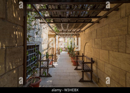 Passage ceiled with wooden pergola leading to the House of Egyptian ...
