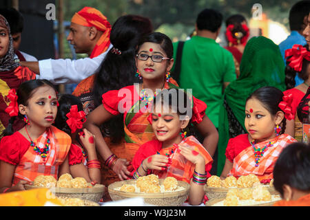 Young dancers offer the baskets of traditional sweet 'Moa' made of ...