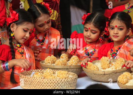 Young dancers offer the baskets of traditional sweet 'Moa' made of ...