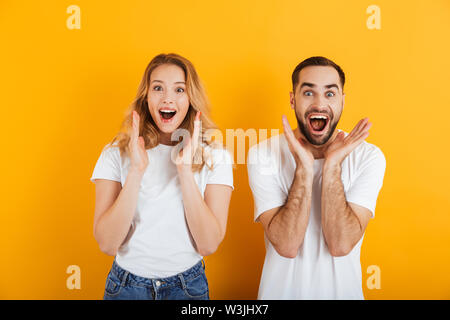 Image of attractive excited couple expressing surprise while using ...