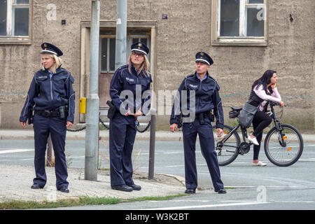 German police officer woman on the Hamburg airport observes passengers ...