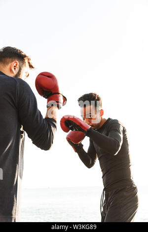 Image of a handsome concentrated young sports man posing isolated over ...