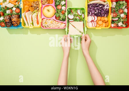 cropped view of woman choosing lunch boxes with food Stock Photo - Alamy