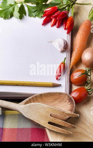 Empty notebook with vegetables on a wooden background Stock Photo - Alamy