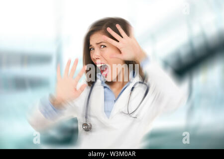 Shocked female doctor screaming Stock Photo - Alamy